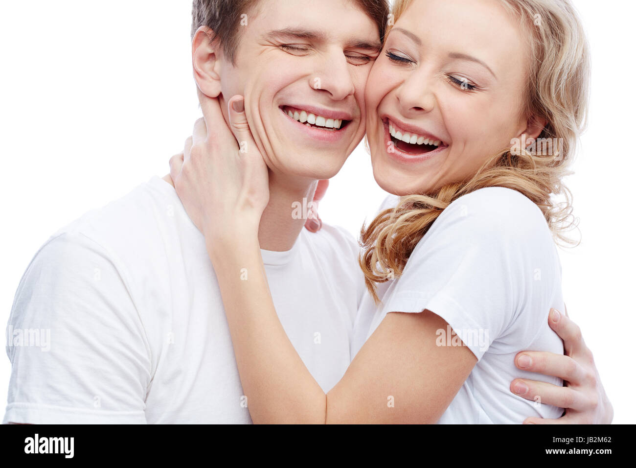 Portrait of amorous young couple touching by faces and laughing Stock ...