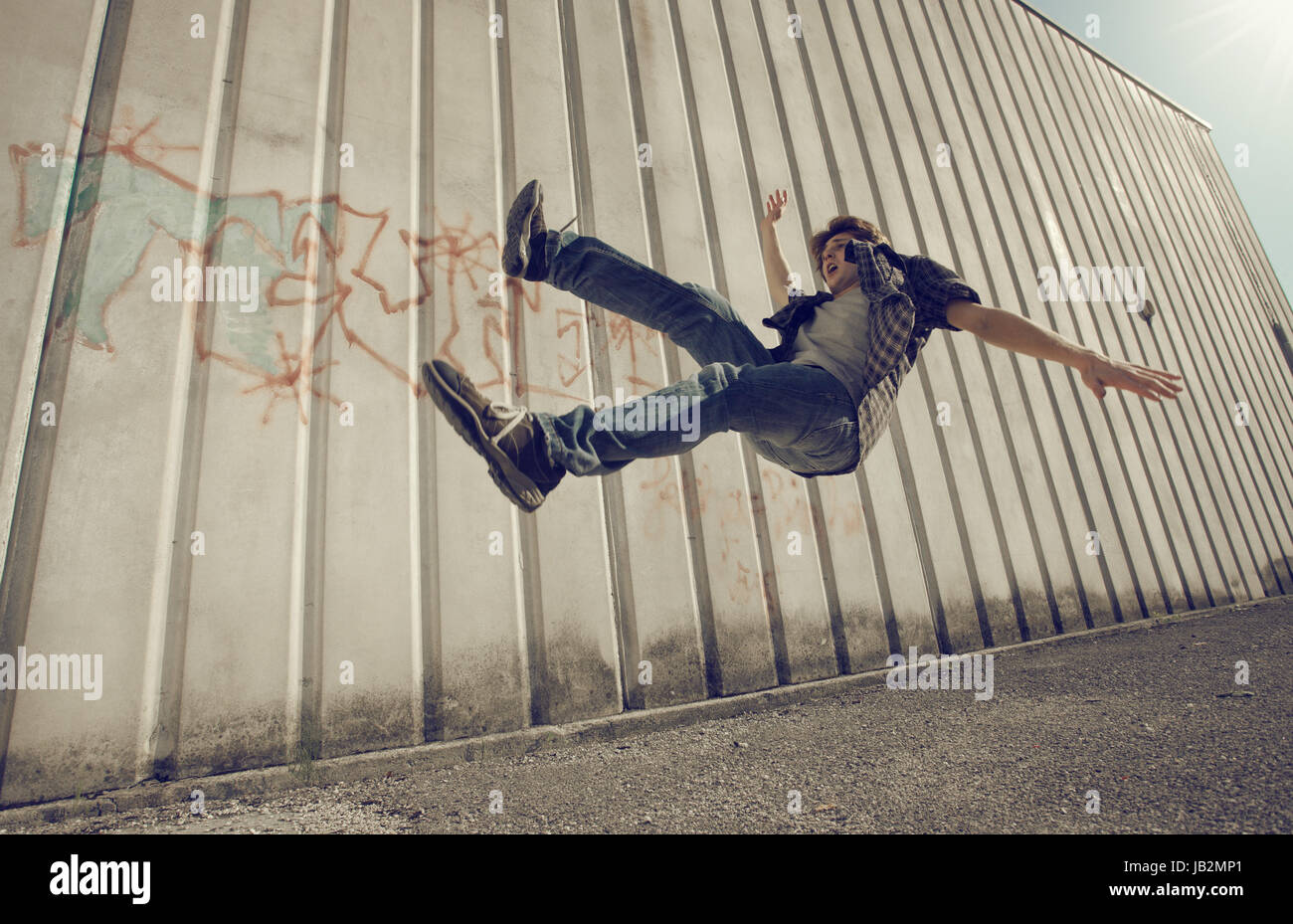 Young man falling from a building Stock Photo - Alamy