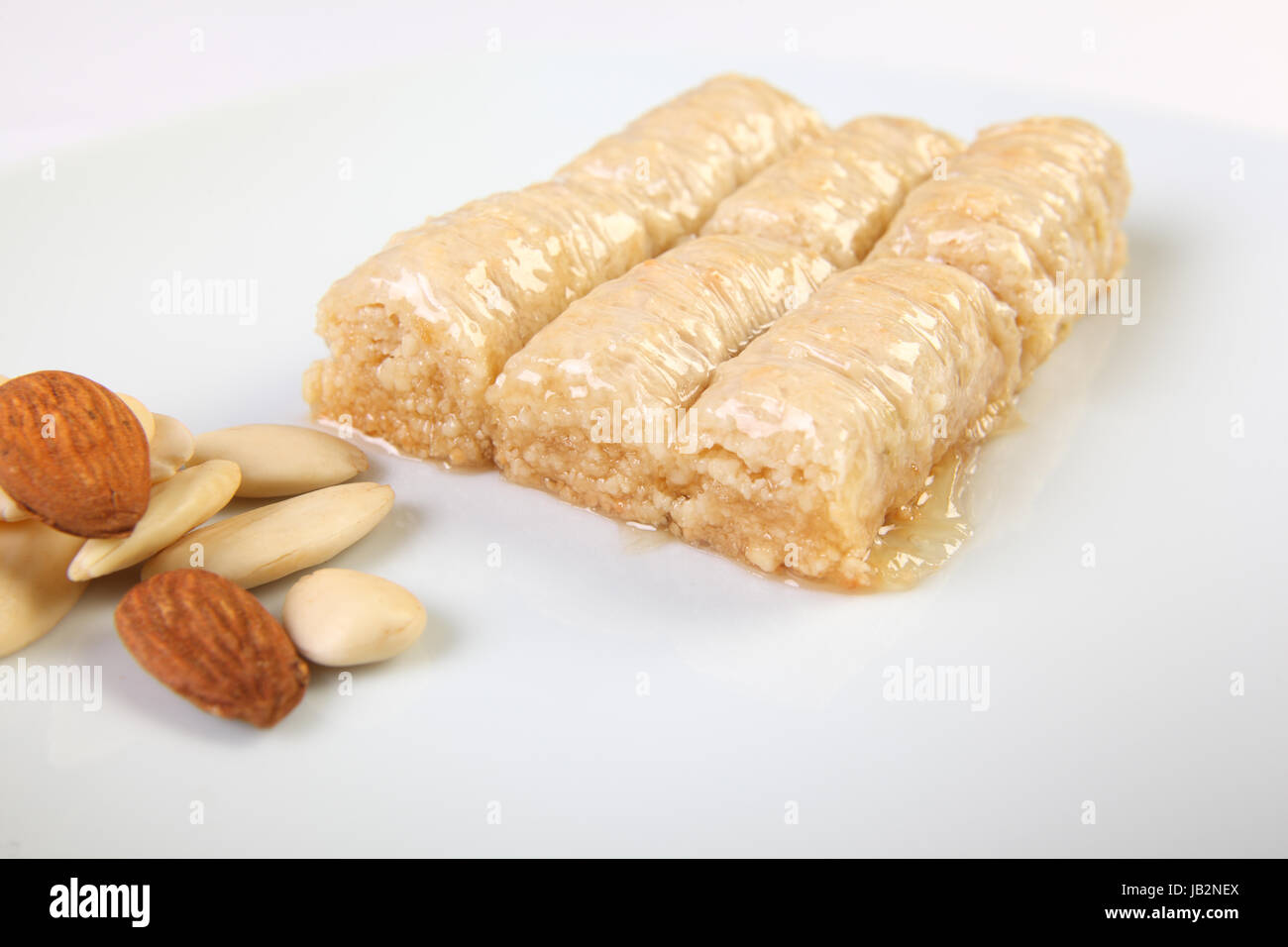 Typical turkish dessert durum with almonds on white background Stock ...