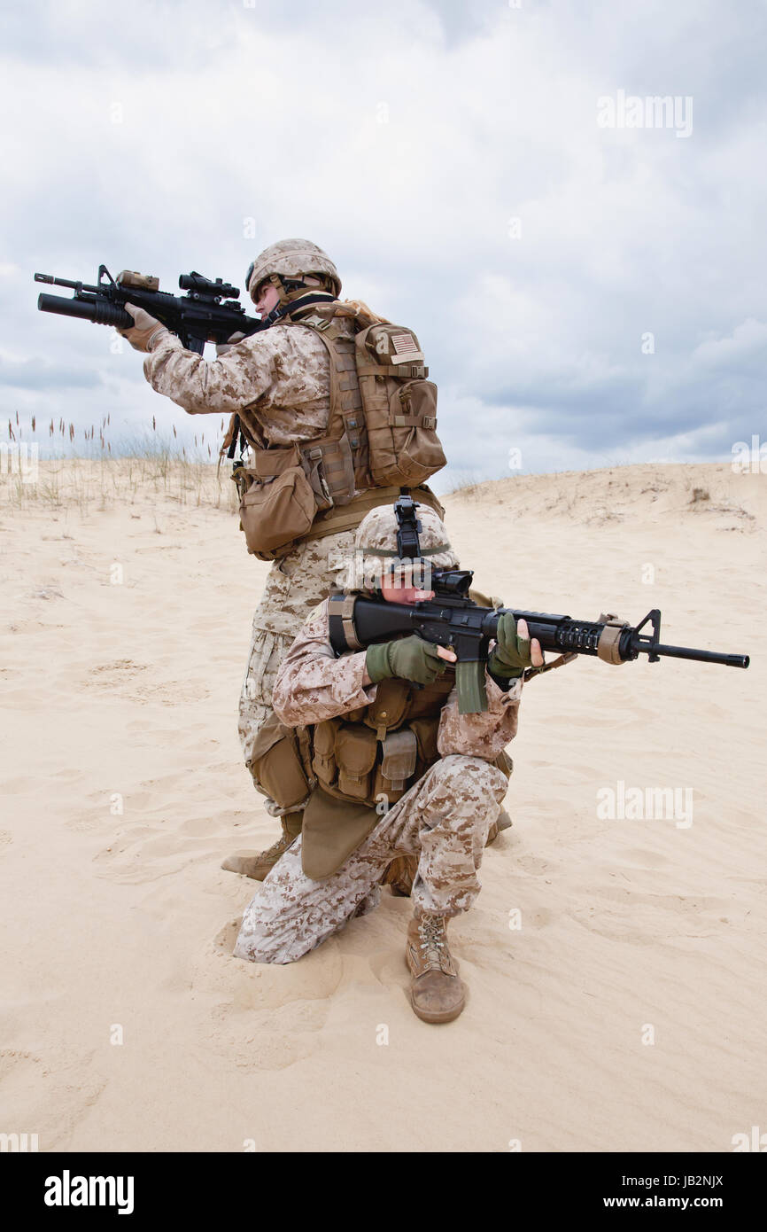 two US marines aim at different directions covering each other Stock ...
