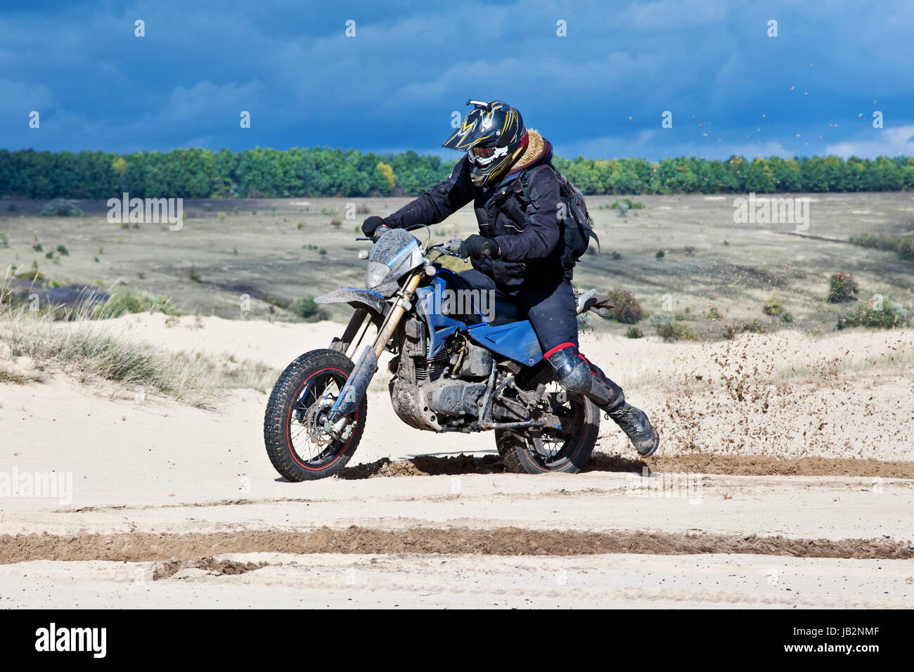 Enduro bike rider driving across the desert Stock Photo - Alamy