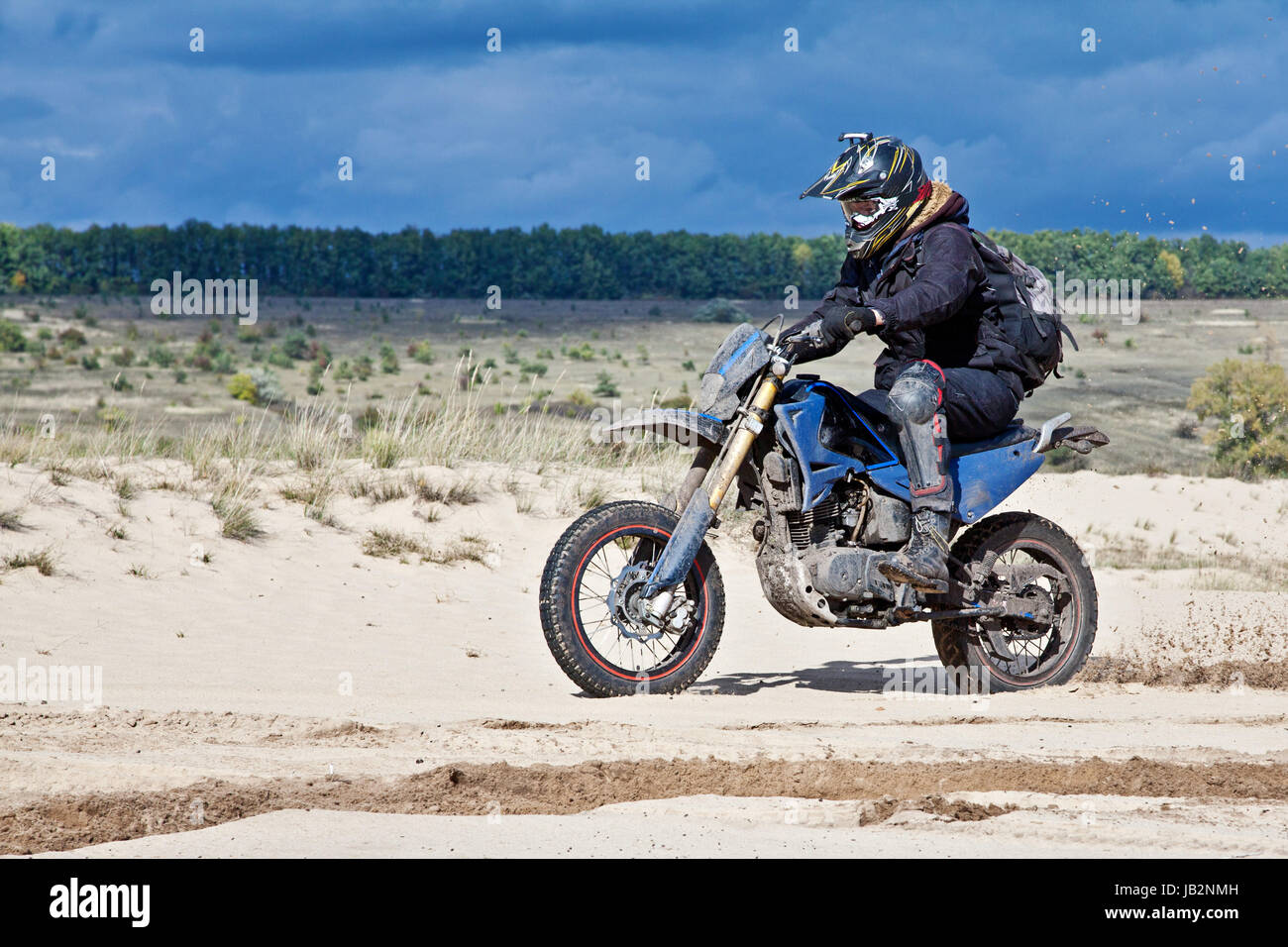 Enduro bike rider driving across the desert Stock Photo - Alamy