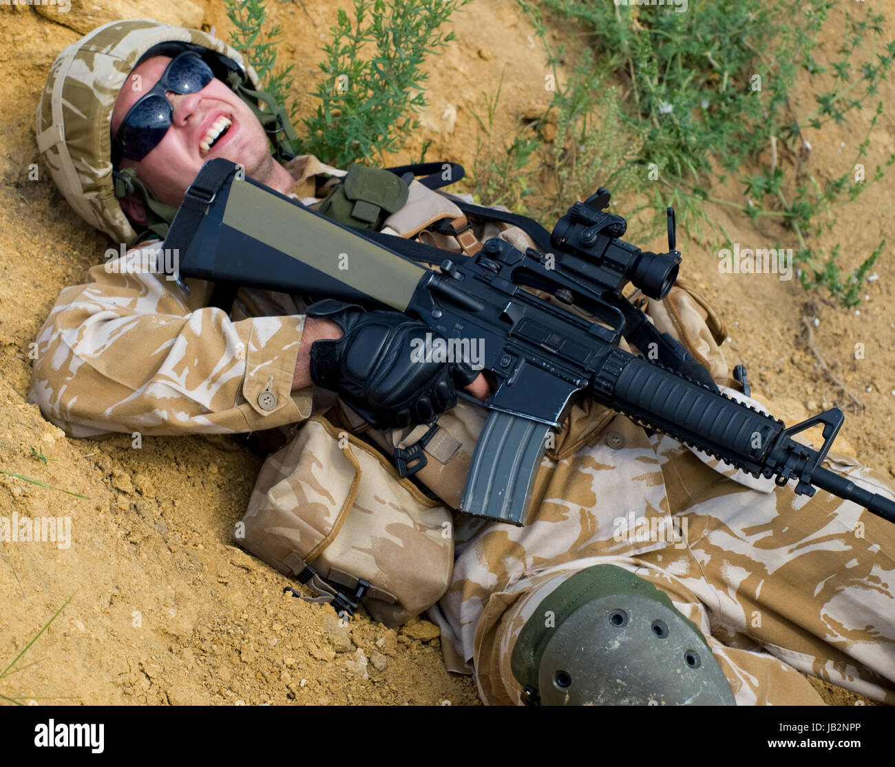 British soldier in desert uniform lying wounded Stock Photo - Alamy