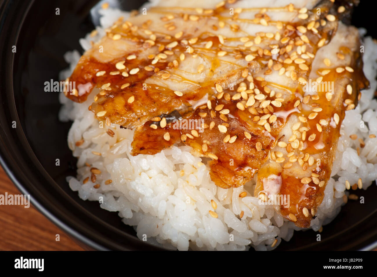Japanese cuisine, eel with rice at black plate Stock Photo - Alamy
