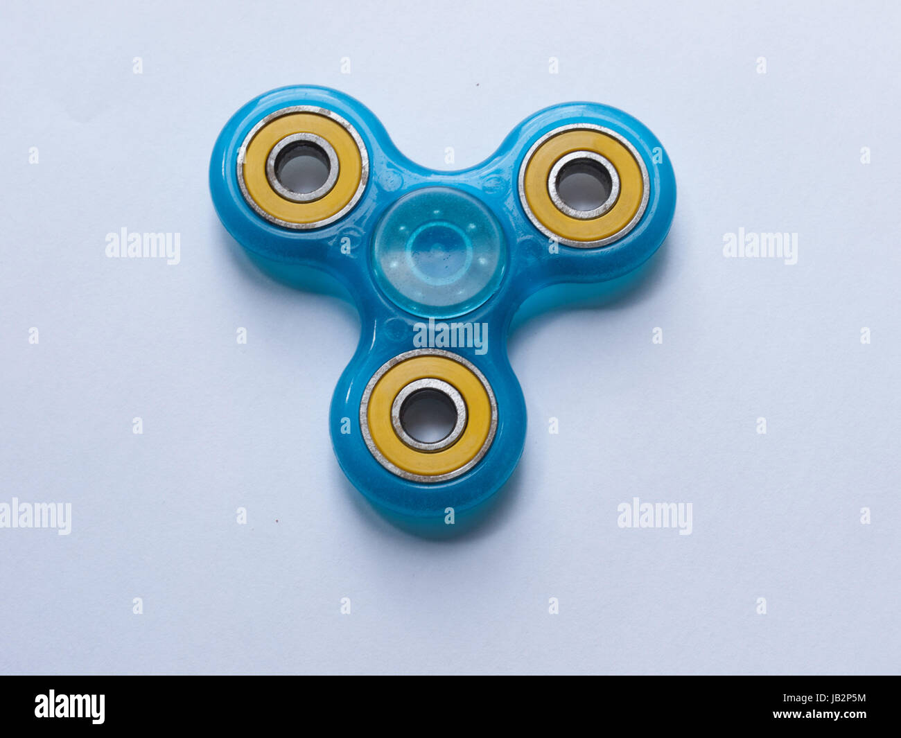 A blue fidget spinner isolated on a white background Stock Photo - Alamy