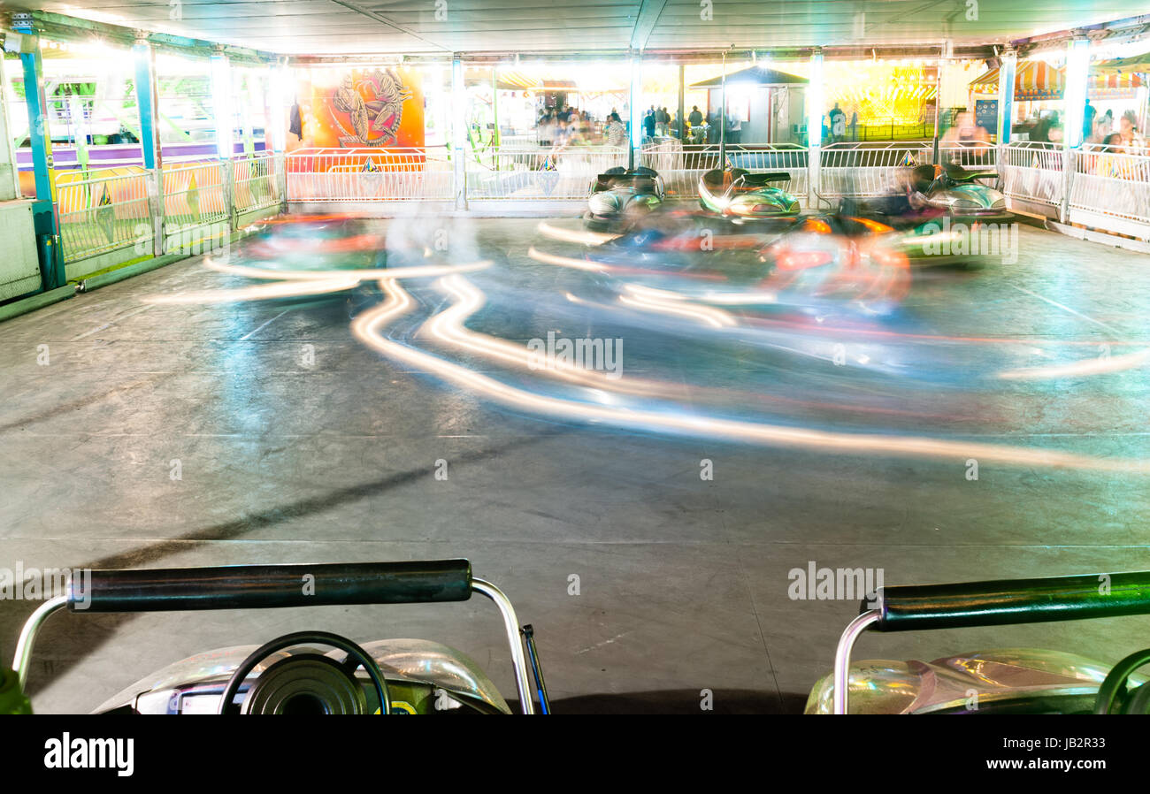 Two sit unused while other bumper cars whirl around the track Stock ...