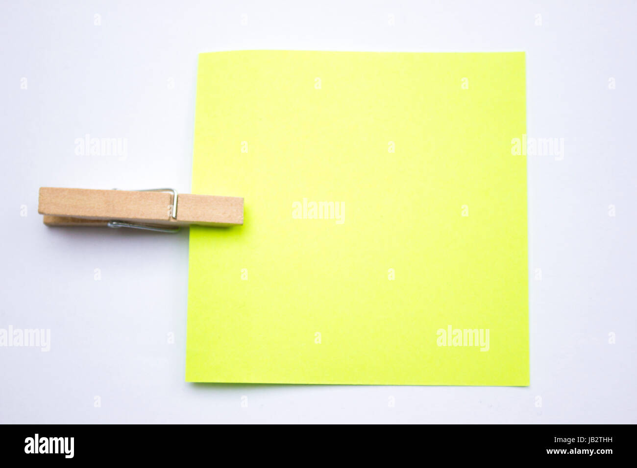 A reminder note pinned with a wooden peg on the side Stock Photo - Alamy