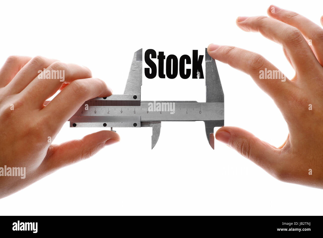 Two hands holding a caliper, measuring the word "Stock Stock Photo - Alamy