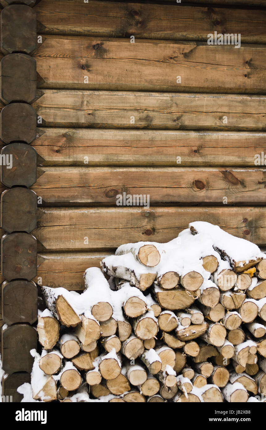 Birch fire wood at a wall of the house in winter Stock Photo - Alamy