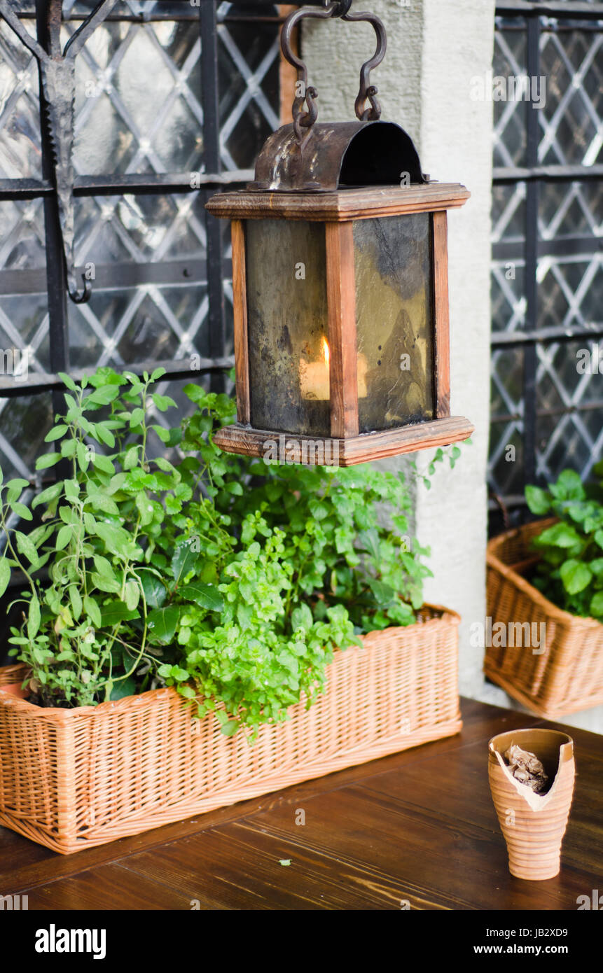 Lantern above a little table of street cafe Stock Photo - Alamy