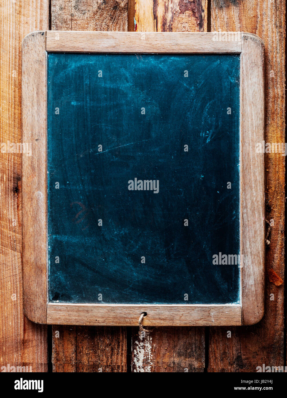 Vintage style wood framed chalkboard over old wood background. Space ...