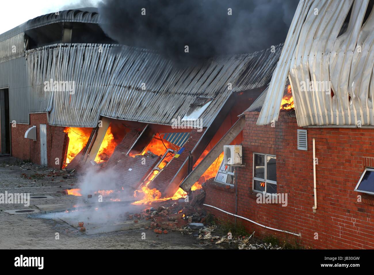 Warehouse building burning with intense flames Stock Photo - Alamy