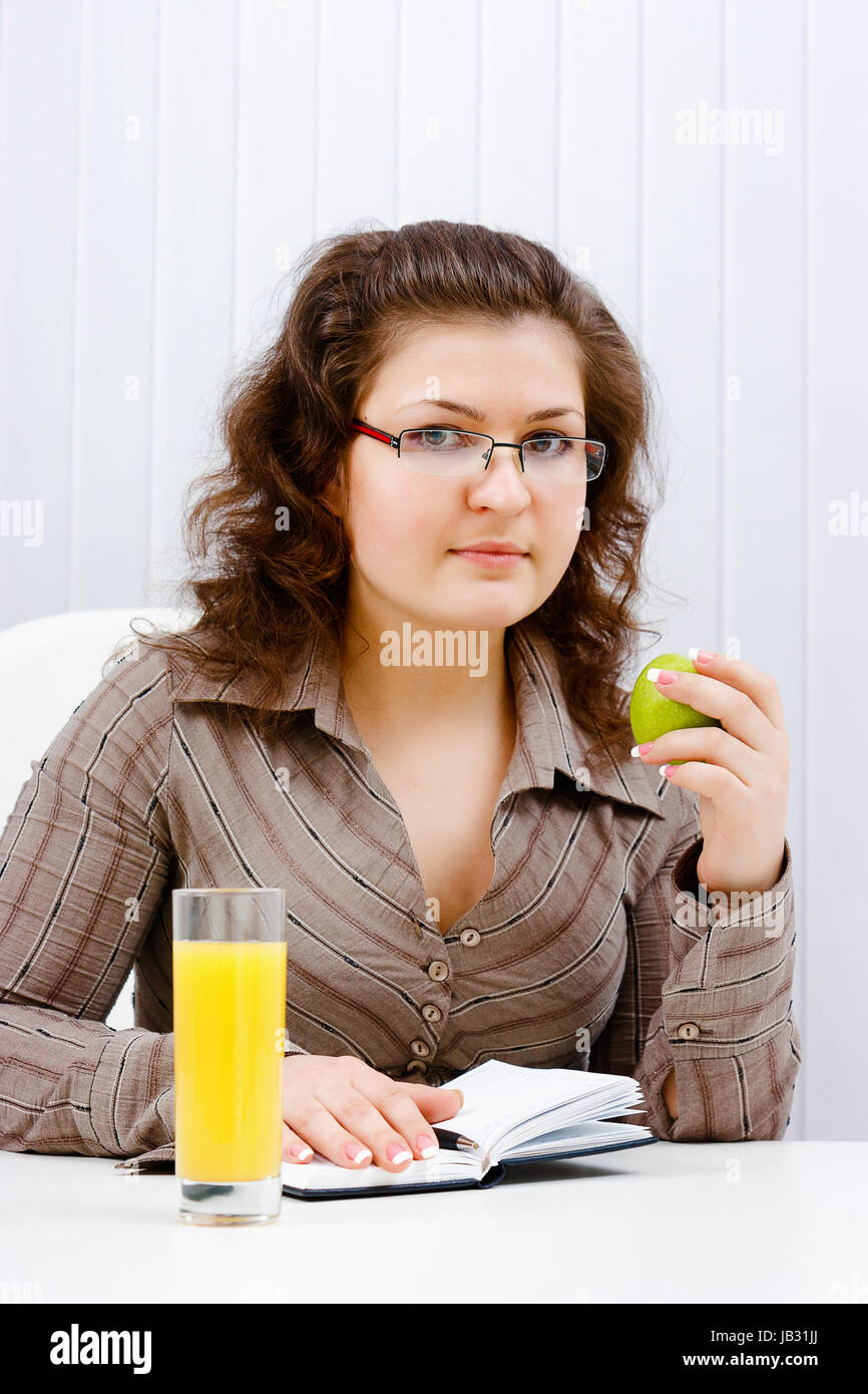 Young woman with a notebook and apple Stock Photo - Alamy