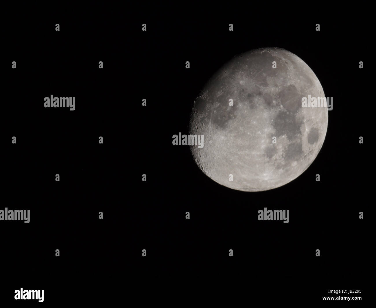 Near full moon seen with a telescope Stock Photo - Alamy