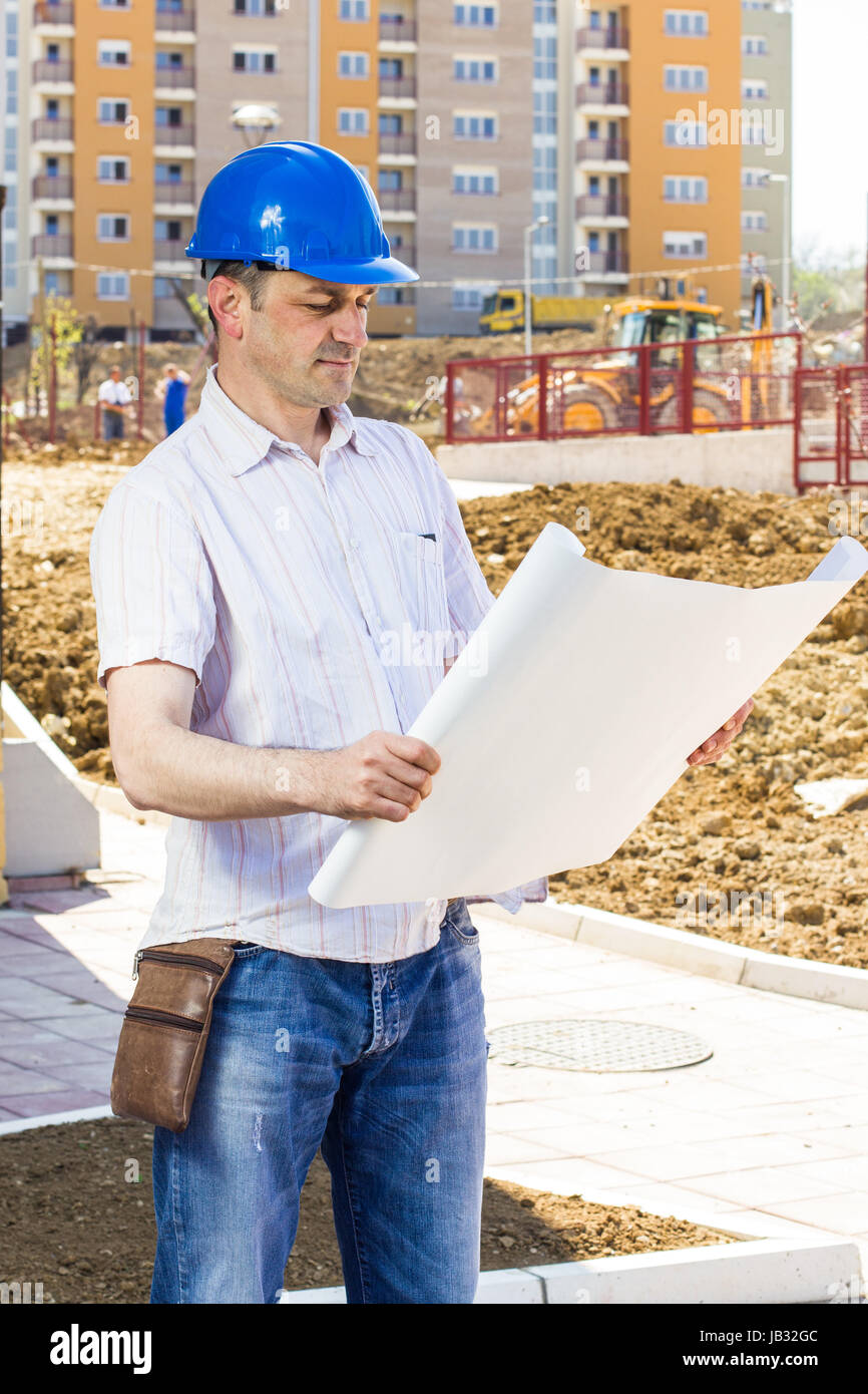 Foreman looking the project on the construction site Stock Photo - Alamy