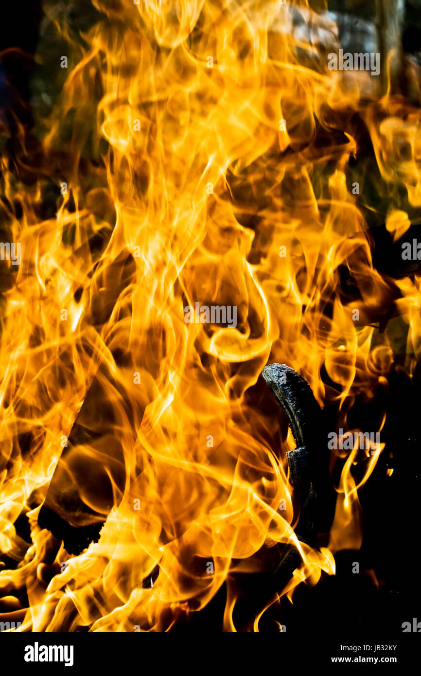 Orange flame burning on black background Stock Photo - Alamy