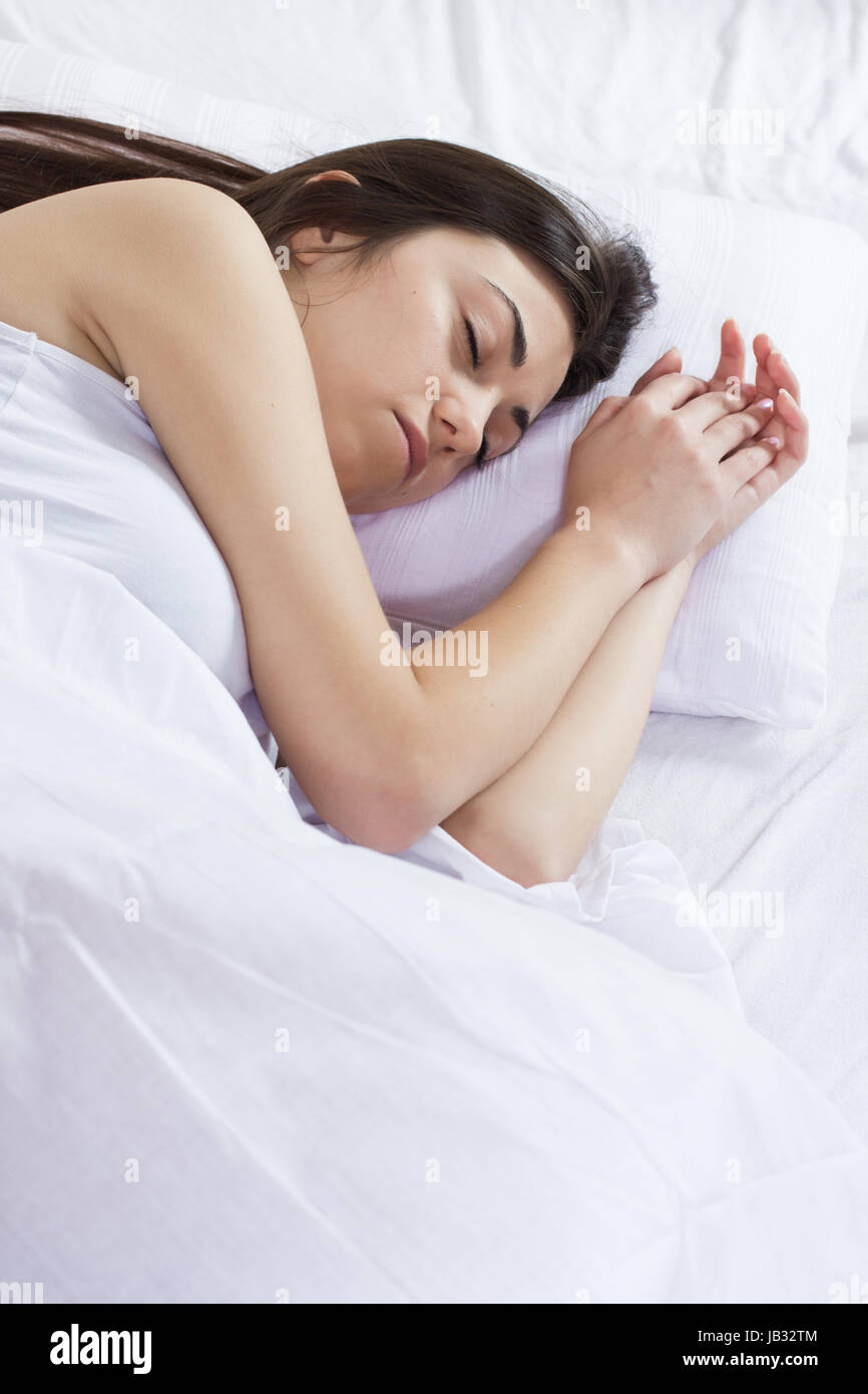 Beautiful young woman sleeping in the bed Stock Photo - Alamy
