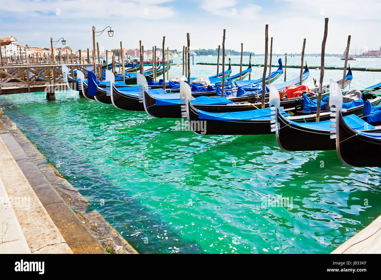 Blue and black gondola boats moored in Venice Stock Photo - Alamy