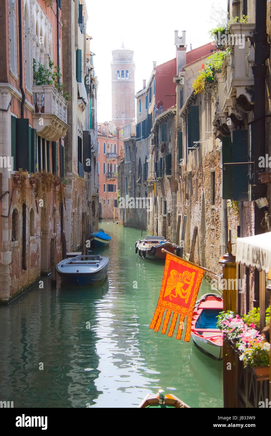 Beautiful canal and traditional venetian flag, Venice, Italy Stock ...