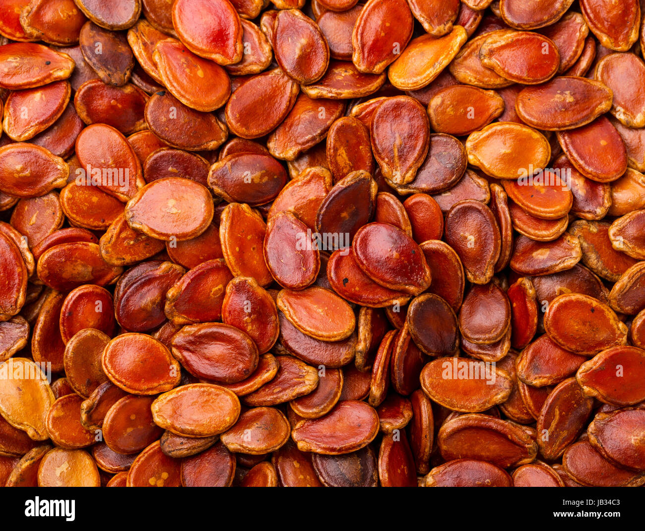 Red melon seeds background Stock Photo - Alamy