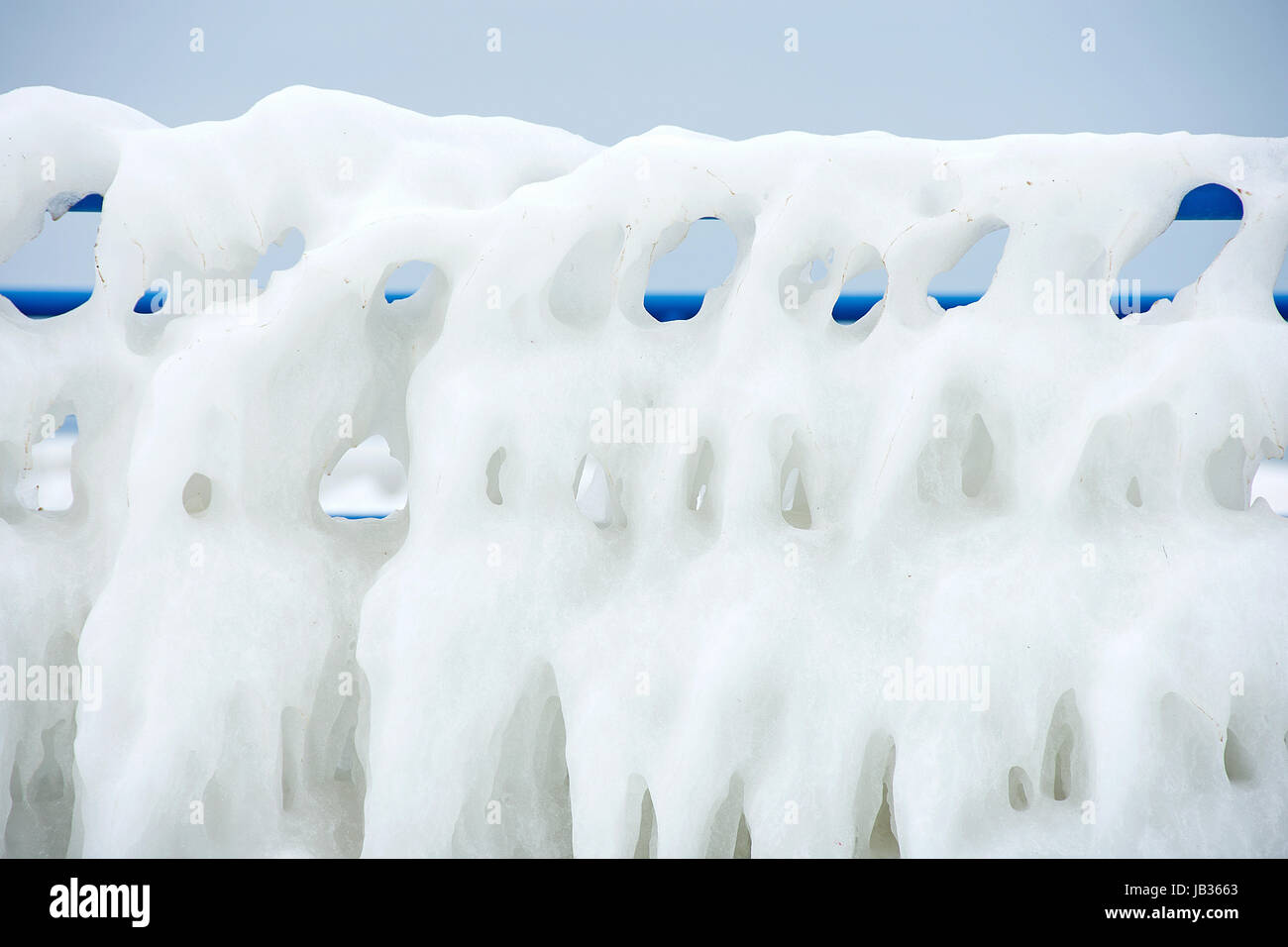melting ice formation on blue railing Stock Photo - Alamy