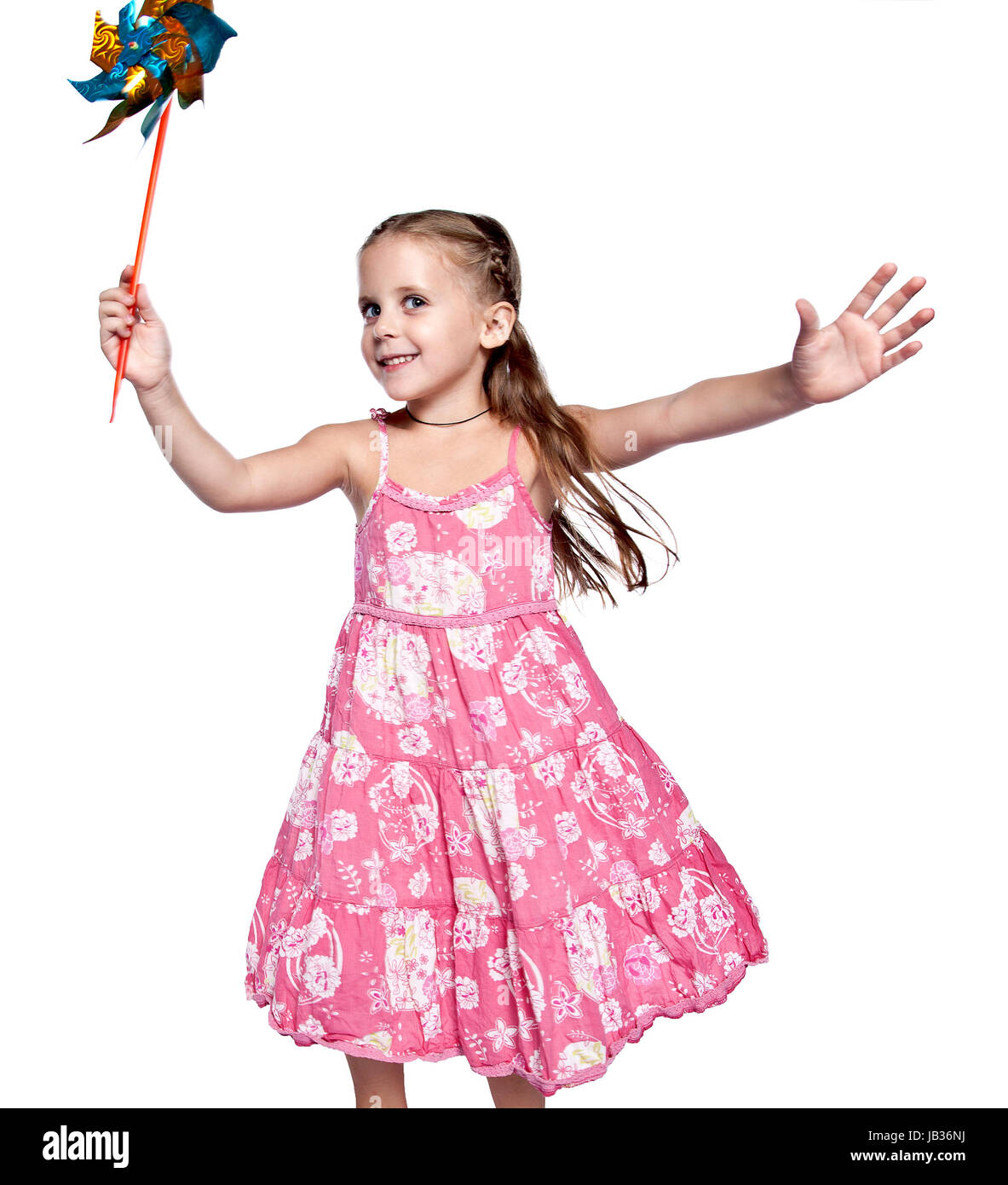 pretty little girl playing with pinwheel Stock Photo - Alamy