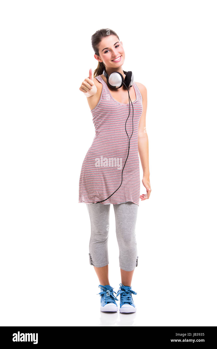 Beautiful young woman listen music with thumbs up, isolated over a ...