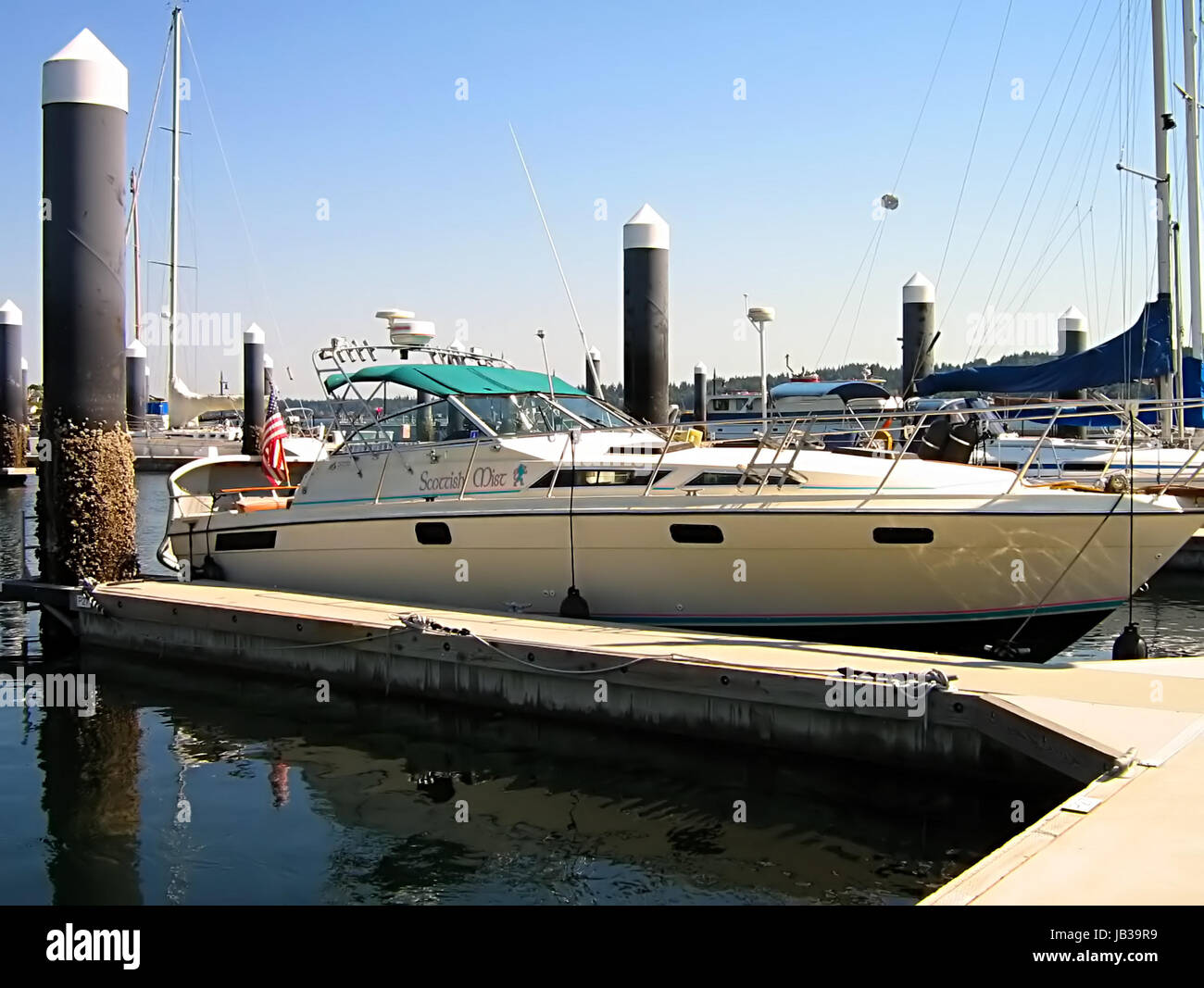 A photograph of a speedboat anchored at a boat dock Stock Photo - Alamy