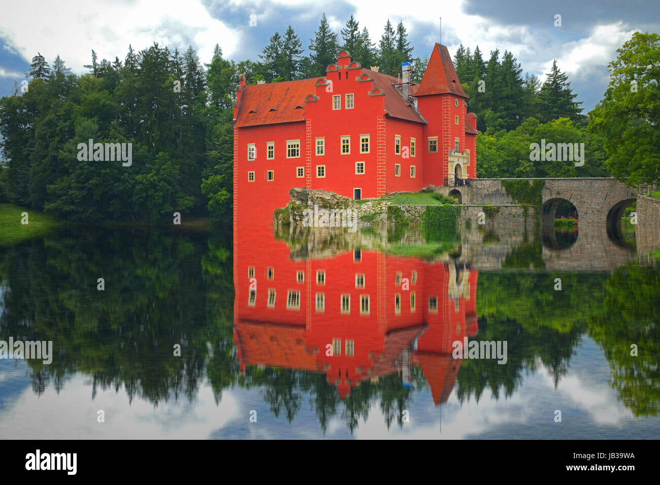 Reflection of the red castle on the lake. State castle Cervena Lhota ...