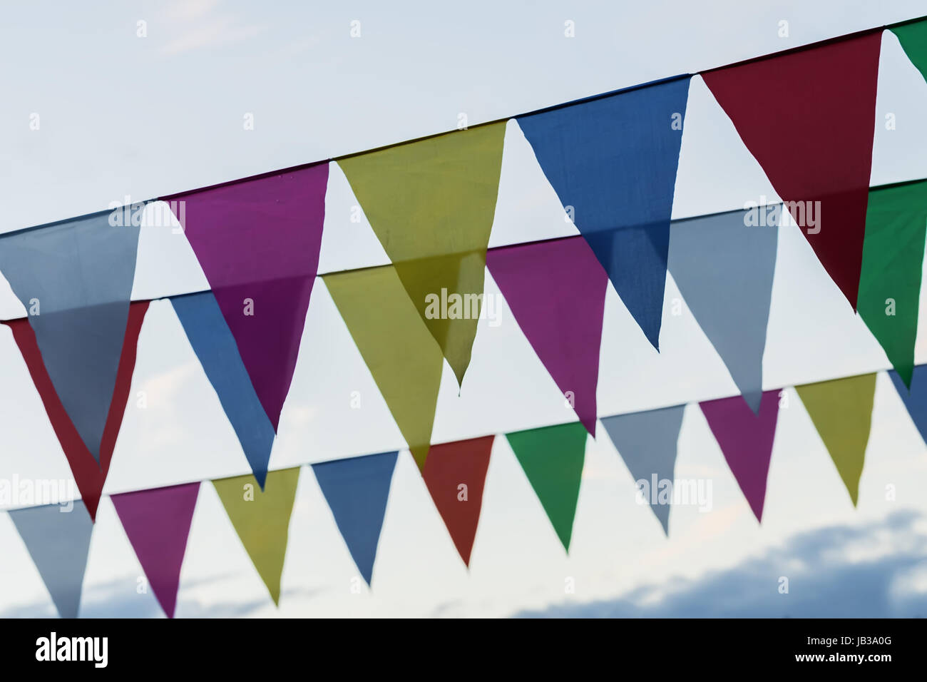 Close-up garland of colorful flags of triangular shape, pennants ...