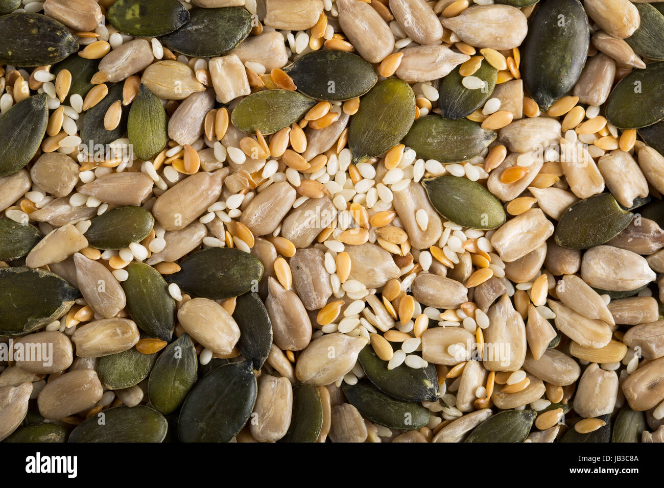 Mixed healthy seeds food background containing pumpkin seeds, sesame ...