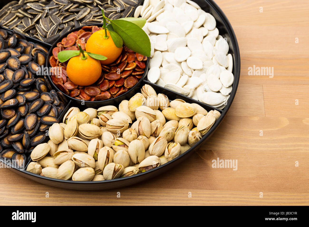Chinese new year snack box and citrus fruit Stock Photo - Alamy