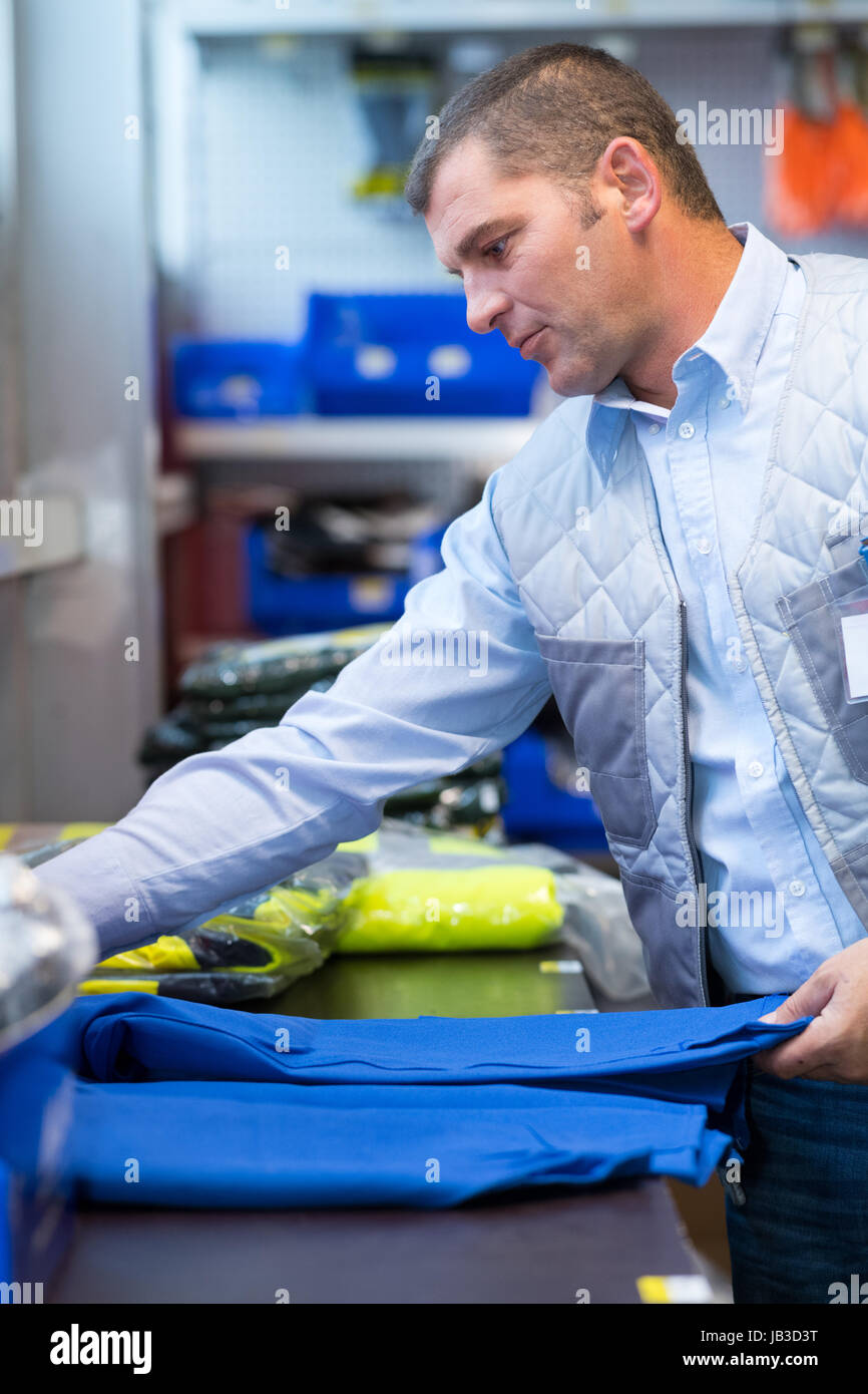 man folding a top Stock Photo - Alamy