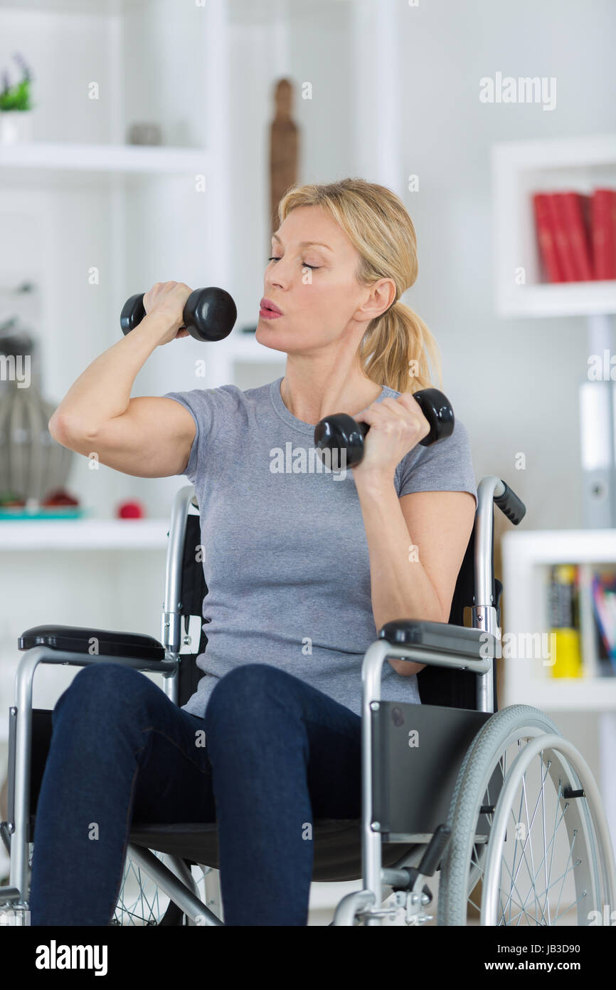 happy handicapped person on a wheelchair with a dumbbell Stock Photo ...