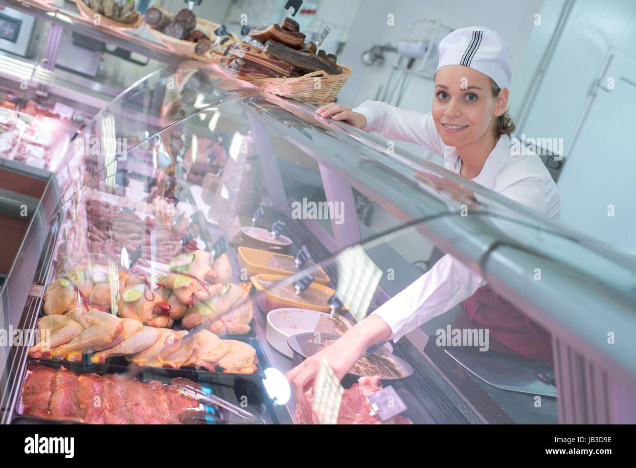 happy female butcher in meat store counter Stock Photo - Alamy
