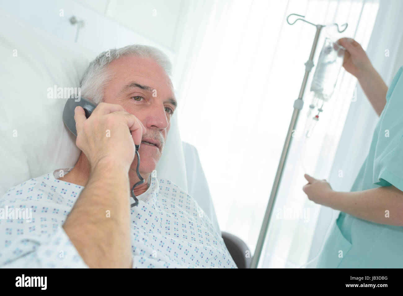 old male patient using mobilephone at dialysis center Stock Photo - Alamy