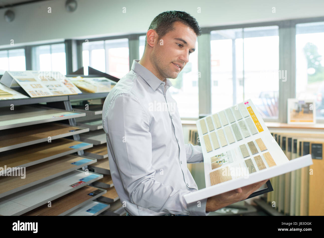 man choosing wood sample planning for home improvement Stock Photo - Alamy