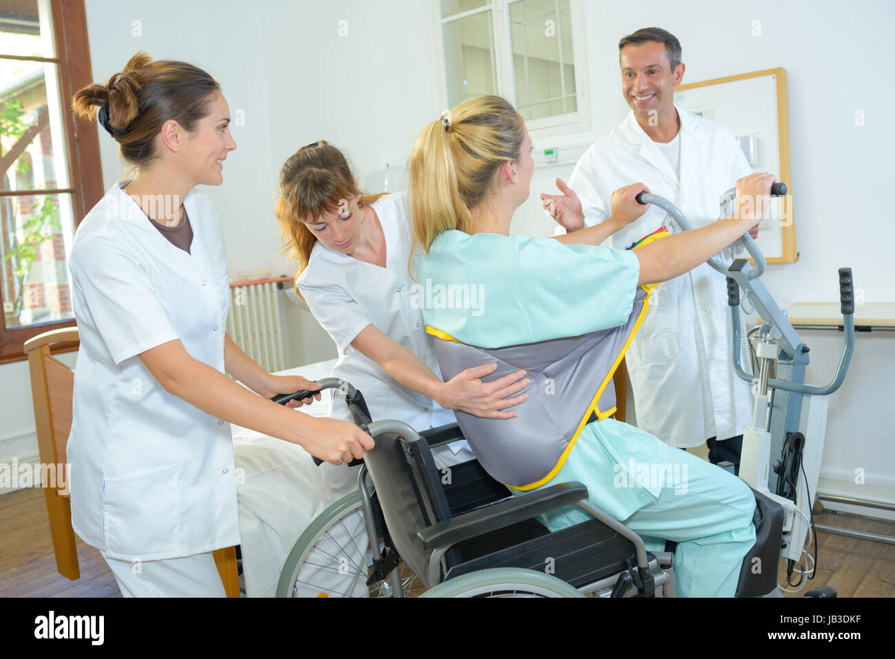 caring male doctor greeting handicapped patient Stock Photo - Alamy