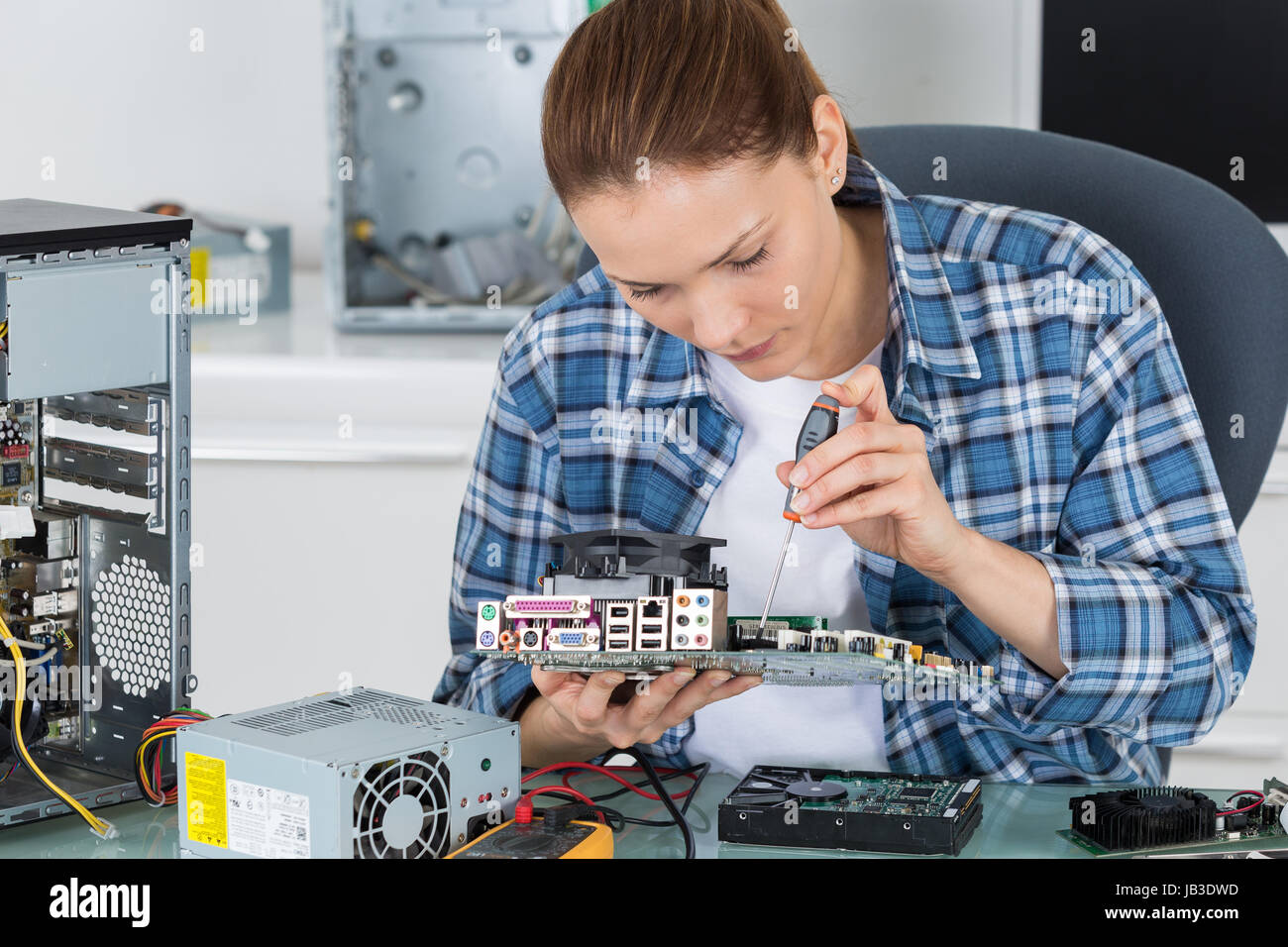 female electronician repairing computer motherboard Stock Photo - Alamy
