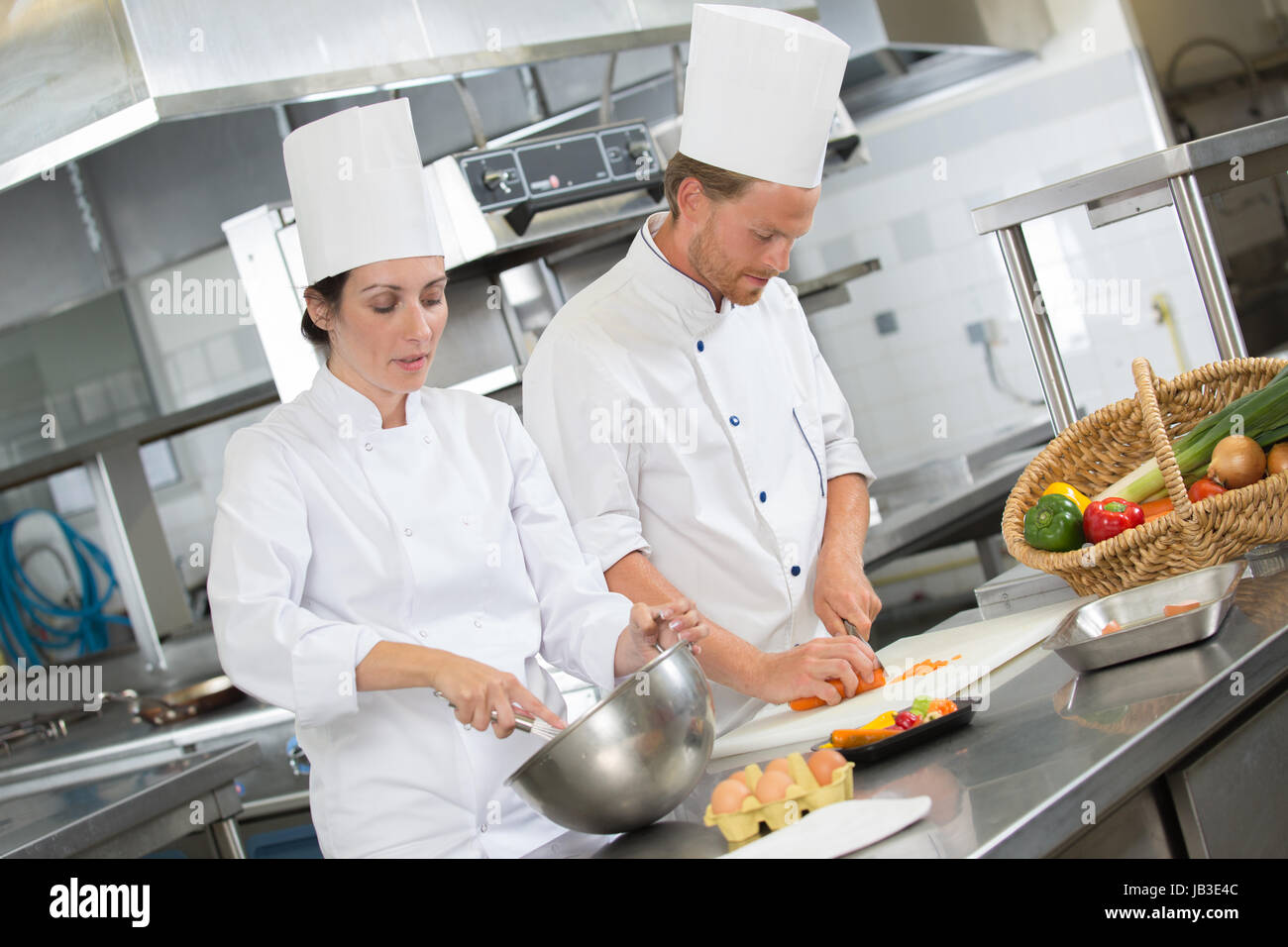 male cooks preparing dishes in restaurant kitchen Stock Photo - Alamy