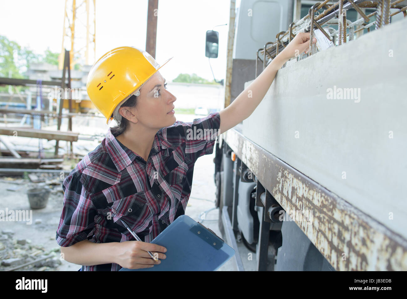 female engineer with clip board wearing safety equipment Stock Photo ...