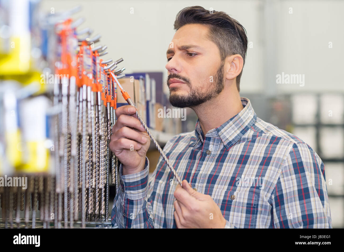 man buying tool in supermarket Stock Photo - Alamy