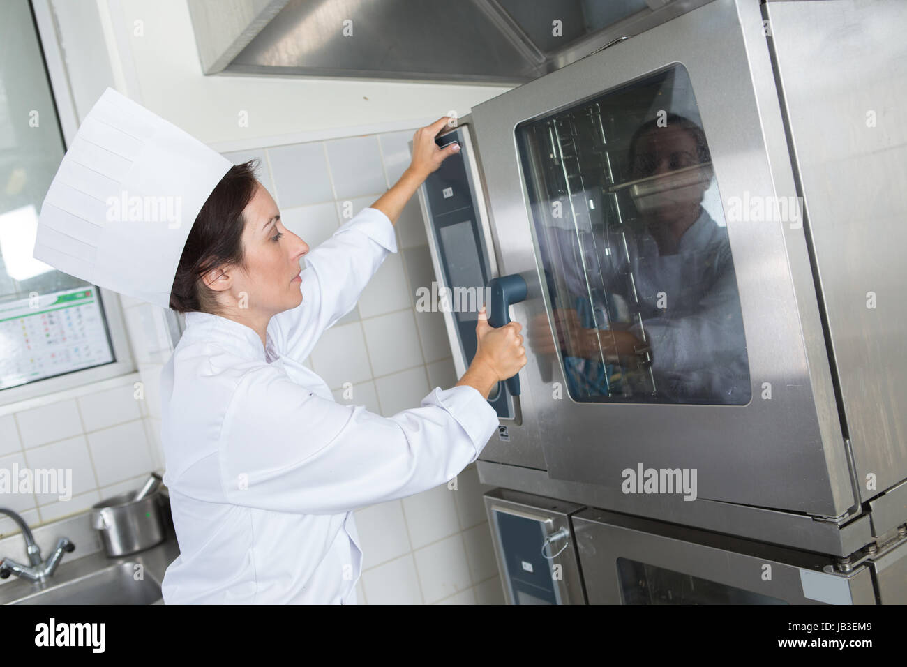 female chef working at kitchen Stock Photo - Alamy