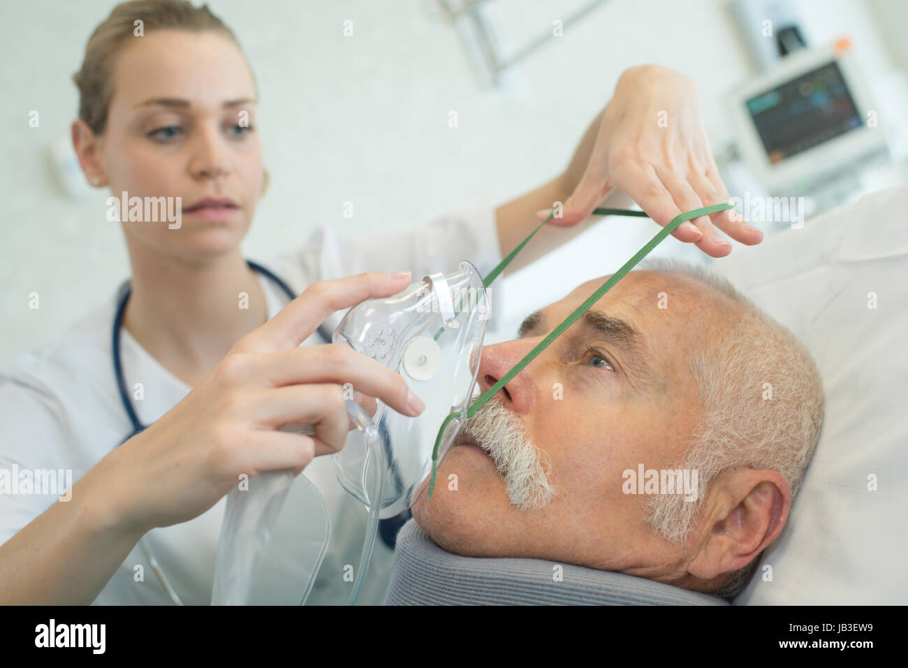 doctor applying oxygen mask on senior patient Stock Photo - Alamy