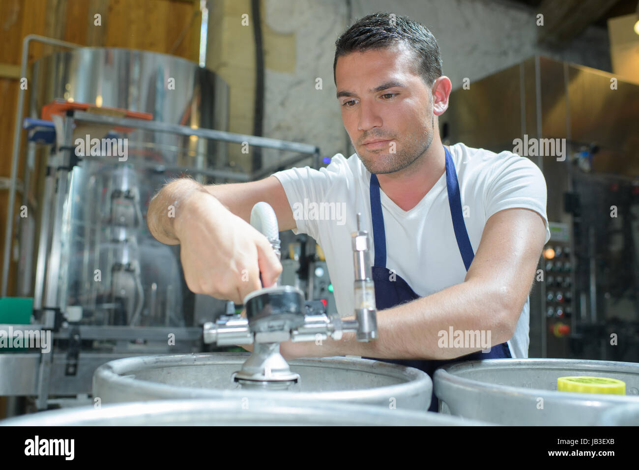 Brewery worker looking steel container hi-res stock photography and ...