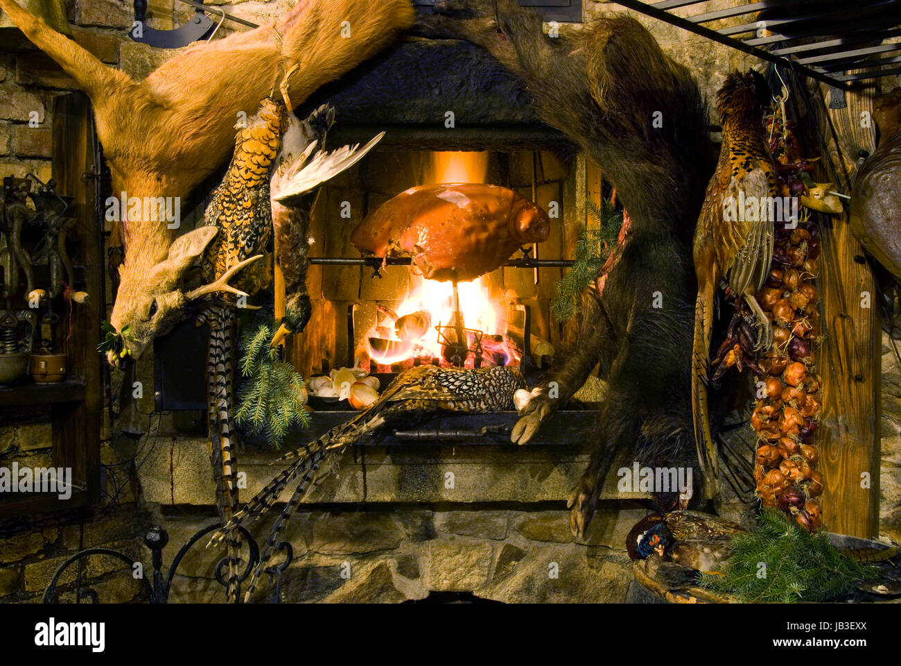 Meat roasting on a fire, venison hanging in front of a fireplace Stock ...