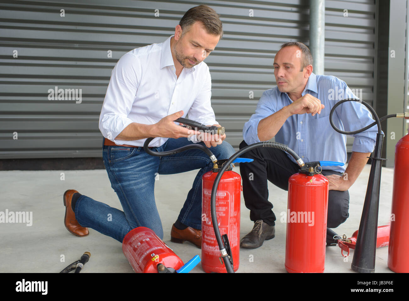 fire extinguisher salesman Stock Photo - Alamy