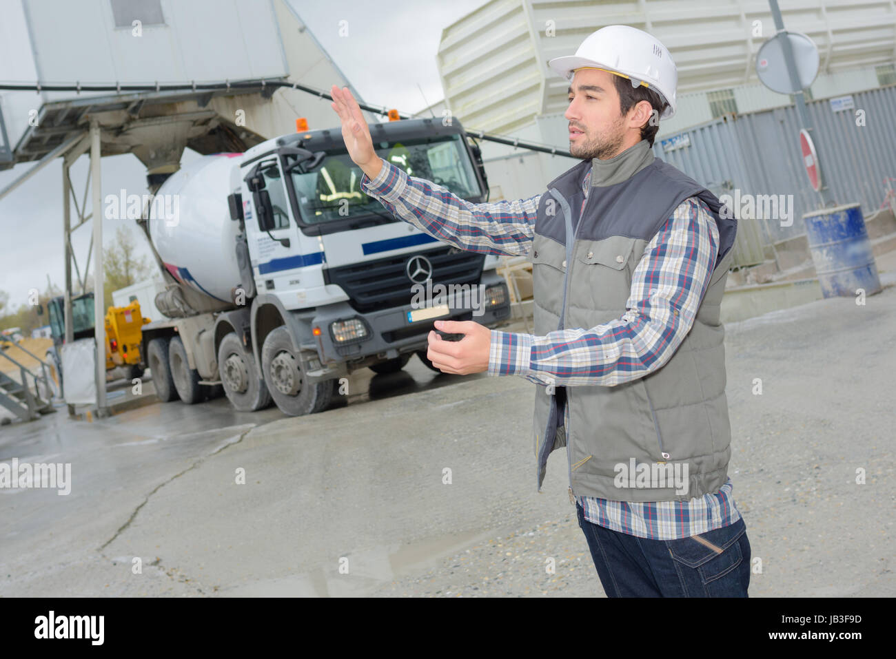 construction expert at cement plant giving stop sign gesture Stock ...