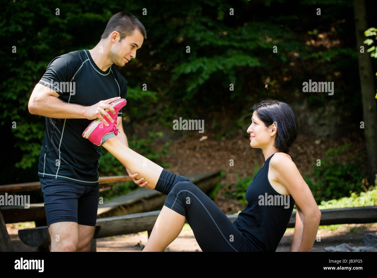 Man Stretches Womans Leg Muscle Spasm After Sport Training Stock Photo Alamy man-stretches-womans-leg-muscle-spasm-after-sport-training-stock-photo-alamy