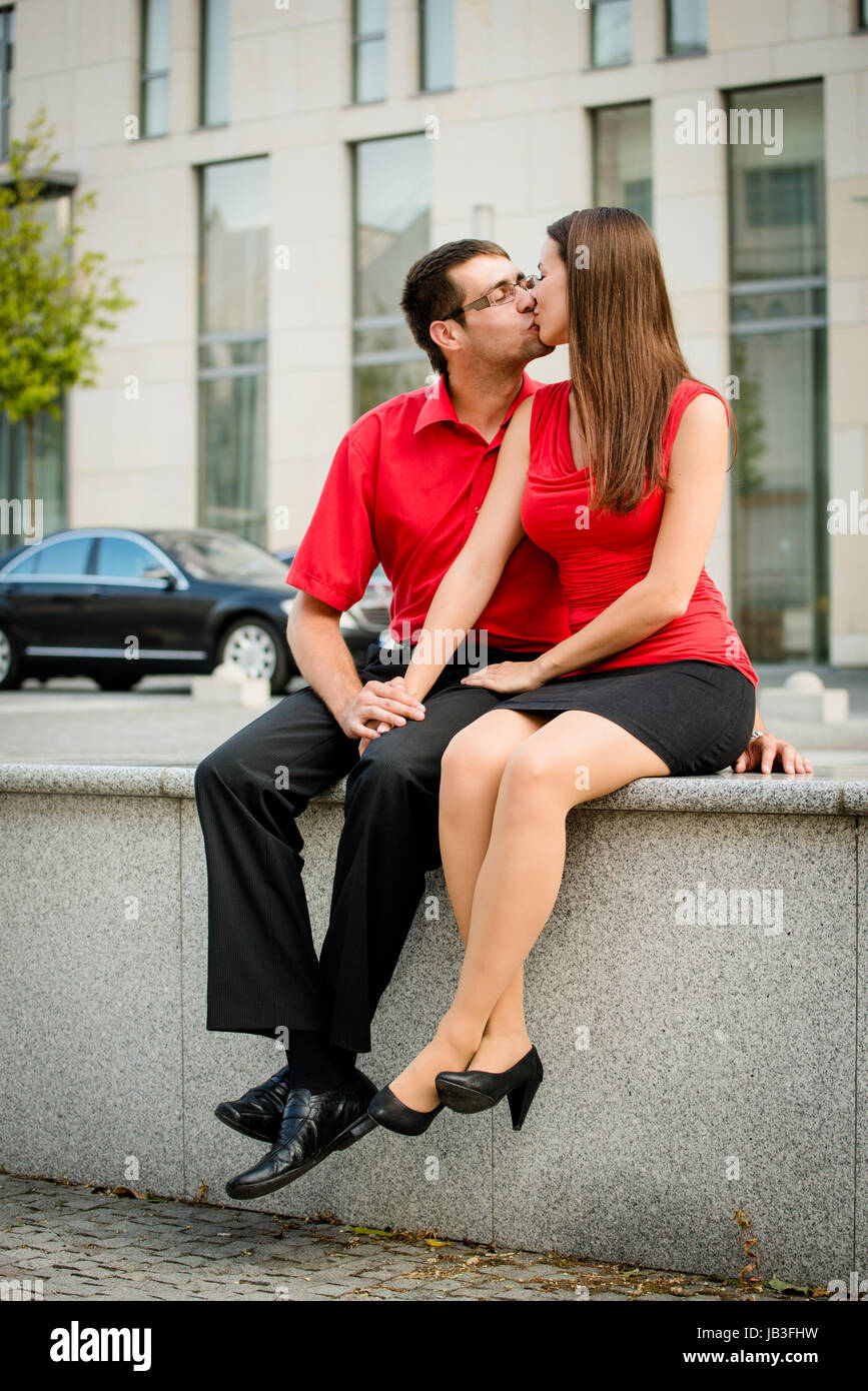 Lifestyle photo of young kissing business people outdoor in street ...